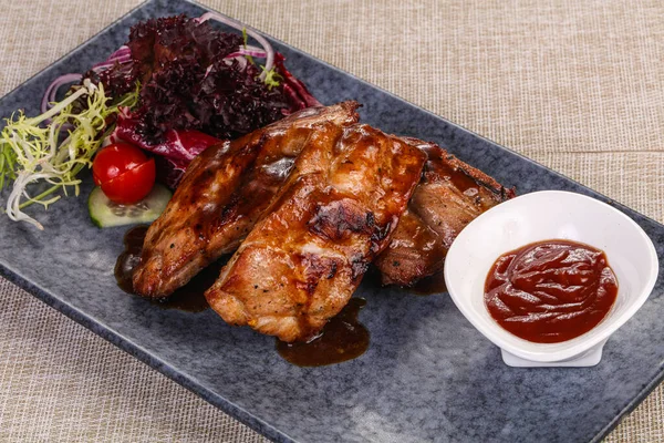 Grilled pork ribs with celery and carrot sticks - Stock Image - Everypixel