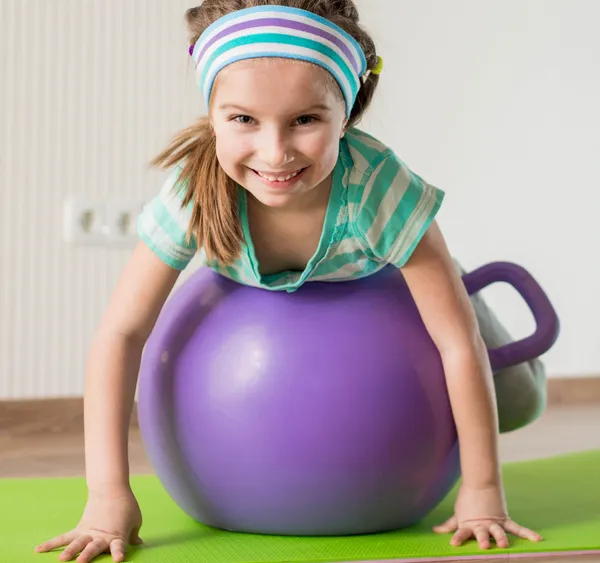 Little girl doing gymnastic exercises Stock Photo by ©tan4ikk 21259203