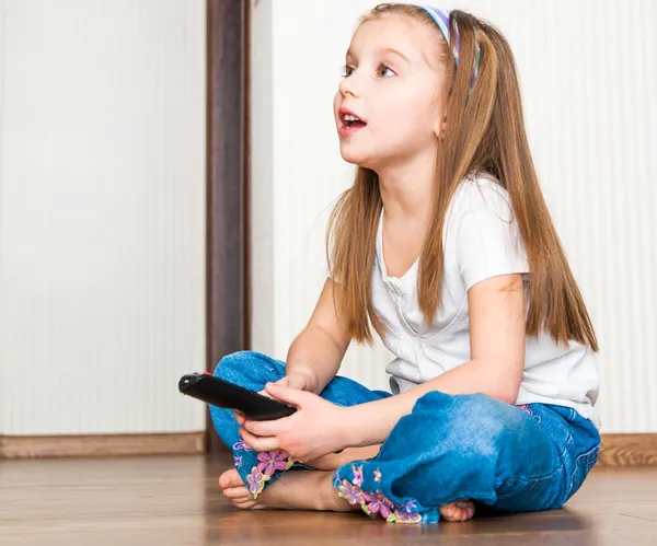Girl holding a remote control — Stock Photo © tan4ikk #21191583