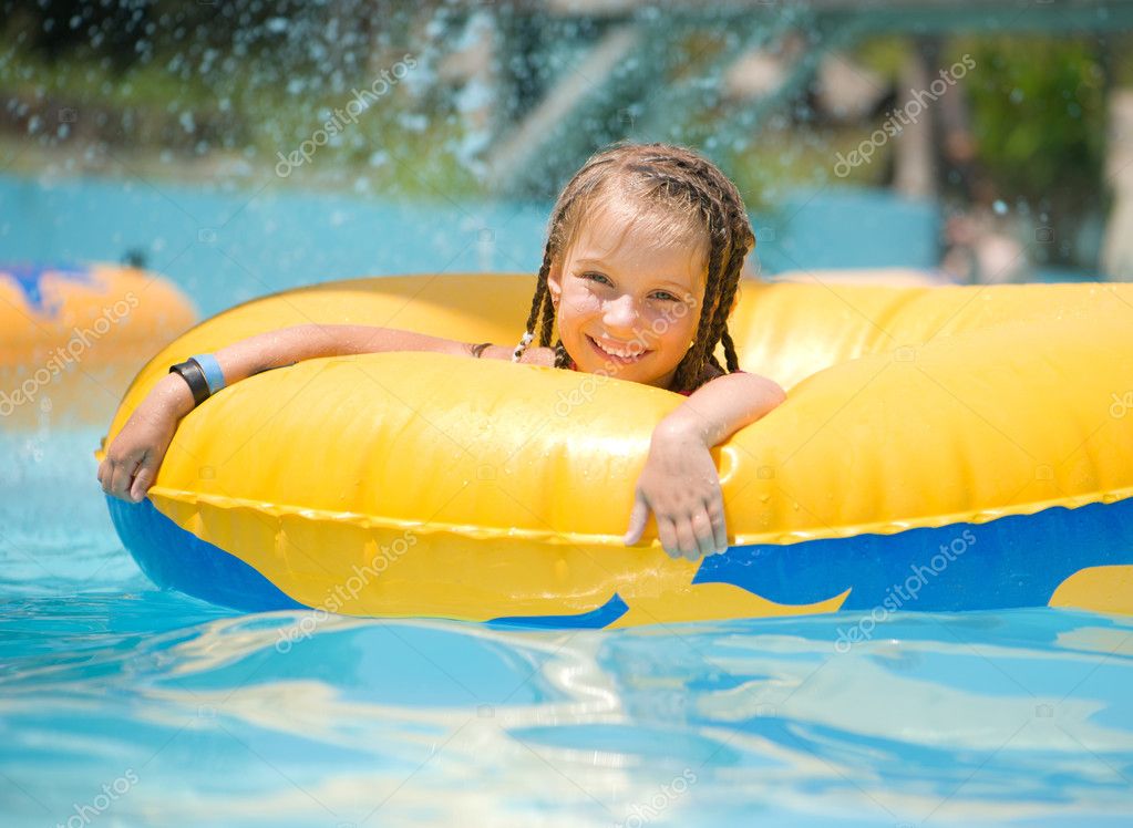 Little girl sitting on inflatable ring — Stock Photo © tan4ikk #22630551