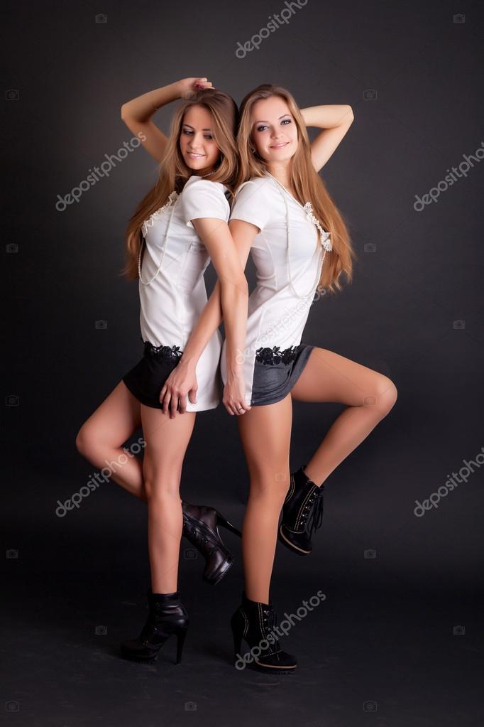 Two beautiful girls twins, isolated on black Stock Photo by ©bloodua ...