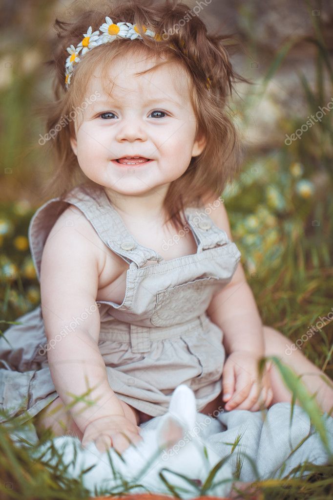 Little girl playing with rabbit in the village. Outdoor. Summer ...