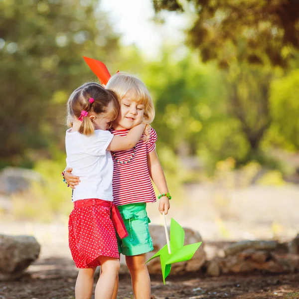 Cute happy children playing in spring filed Stock Photo by ©golyak 37895303