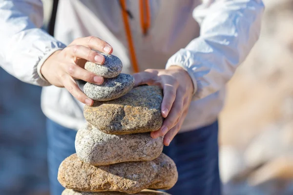 Person stacking stones Stock Photos, Royalty Free Person stacking ...