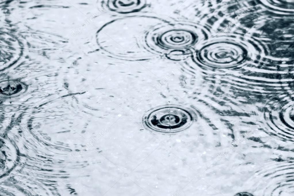 Raindrops falling into a puddle — Stock Photo © MrTwister #31569653