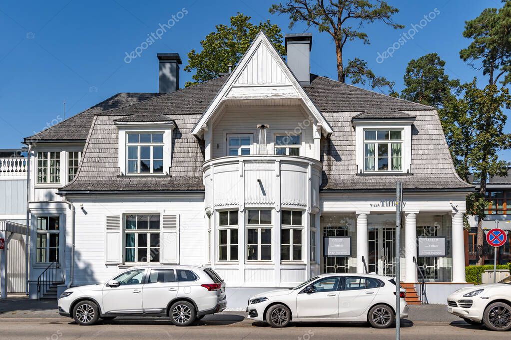 LATVIA, JURMALA, JULY, 2022: Exterior view renovation wooden home among ...