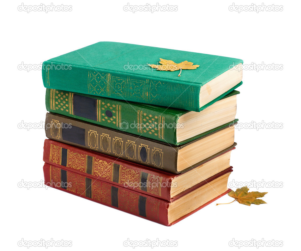 A stack of old books with gold stamping on a white background is Stock ...