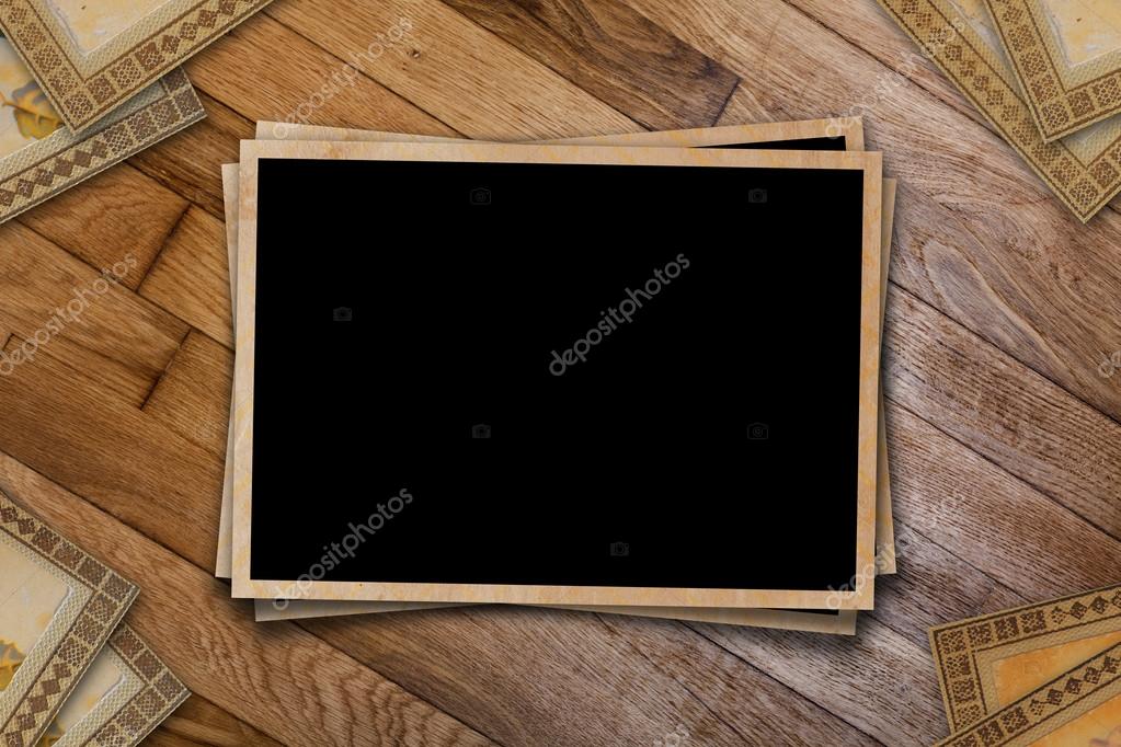 A stack of old postcards and frames on a wooden table Stock Photo by ...