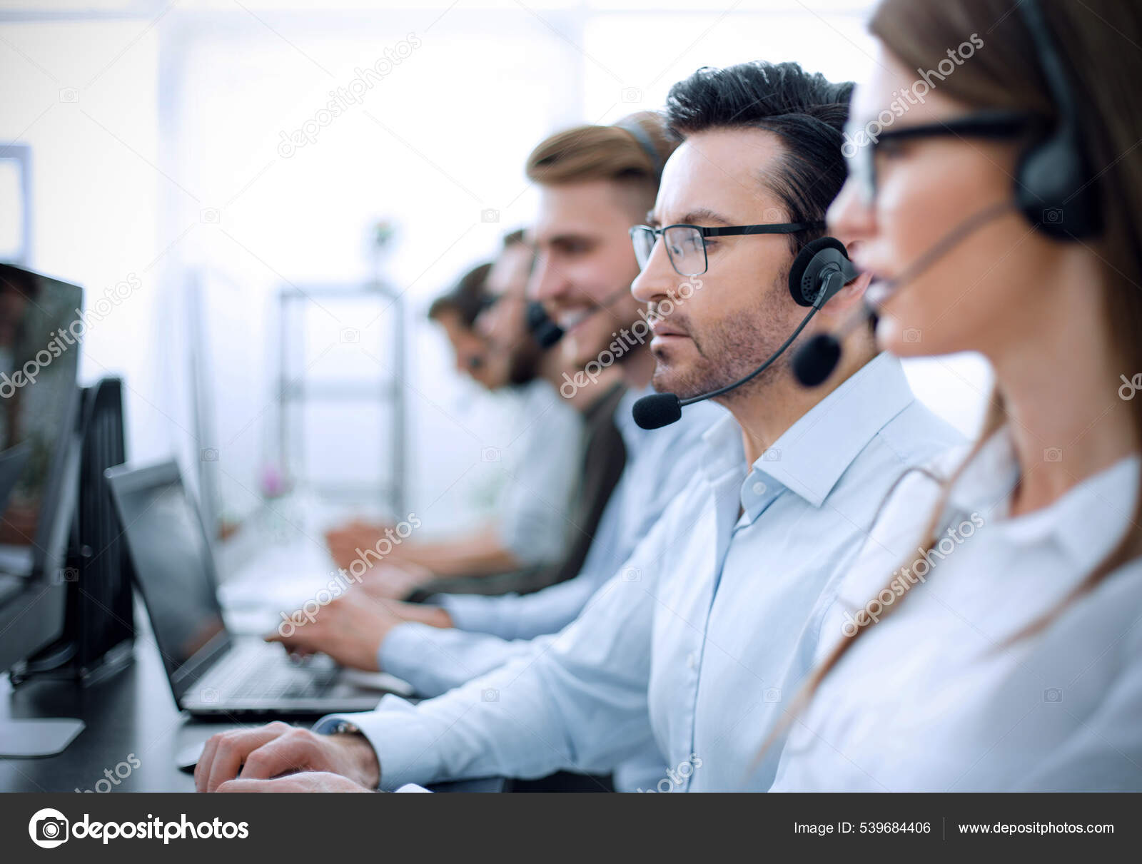 Close up.background image of call center employees in the workplace ...