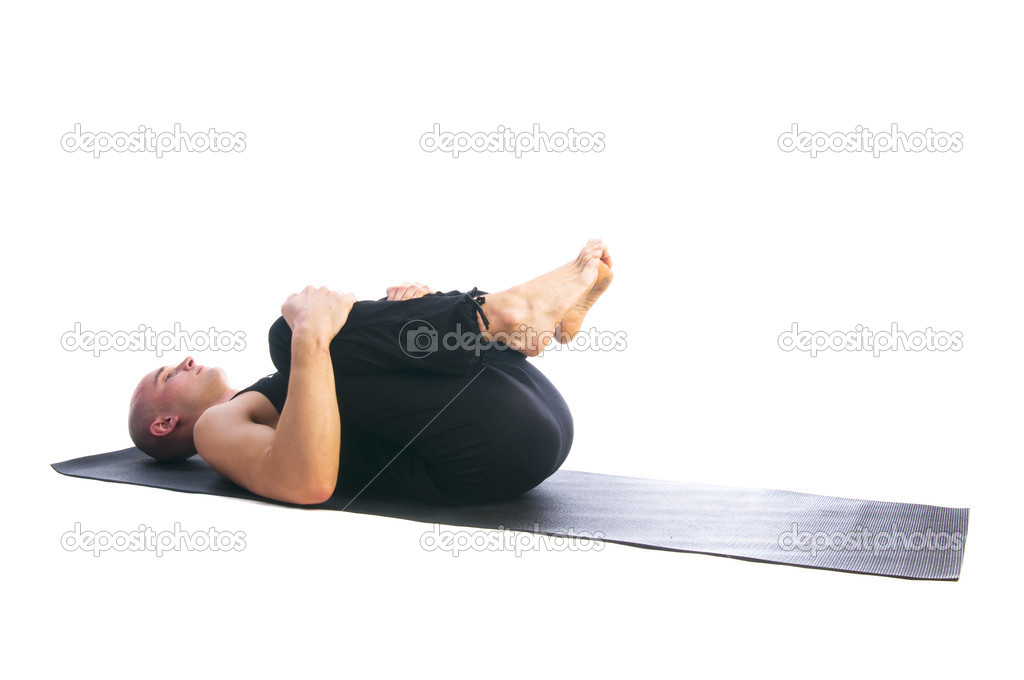 Man in Pavanamuktasana Pose Stock Photo by ©nanka-photo 31348245