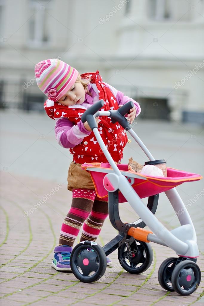 Girl with stroller — Stock Photo © Reanas #38009281