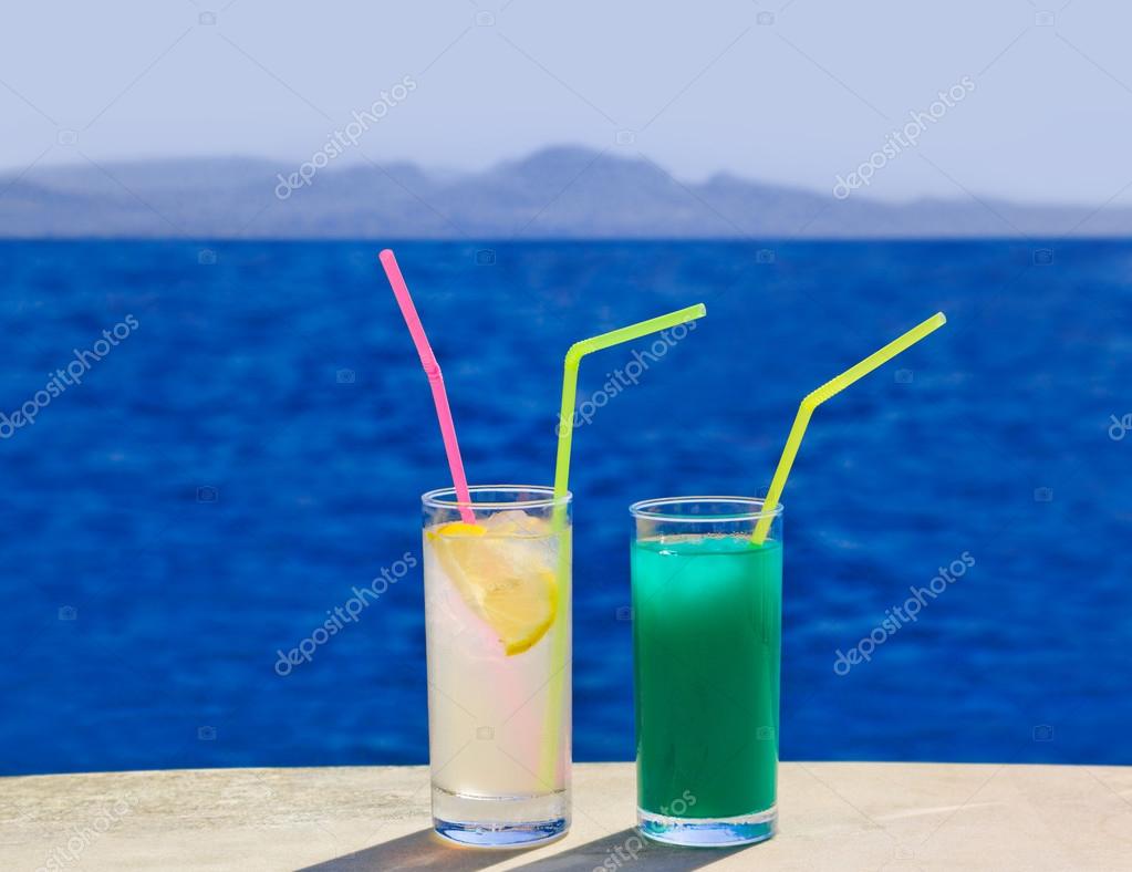 Two cocktails on marble table at beach Stock Photo by ©Violin 13621948