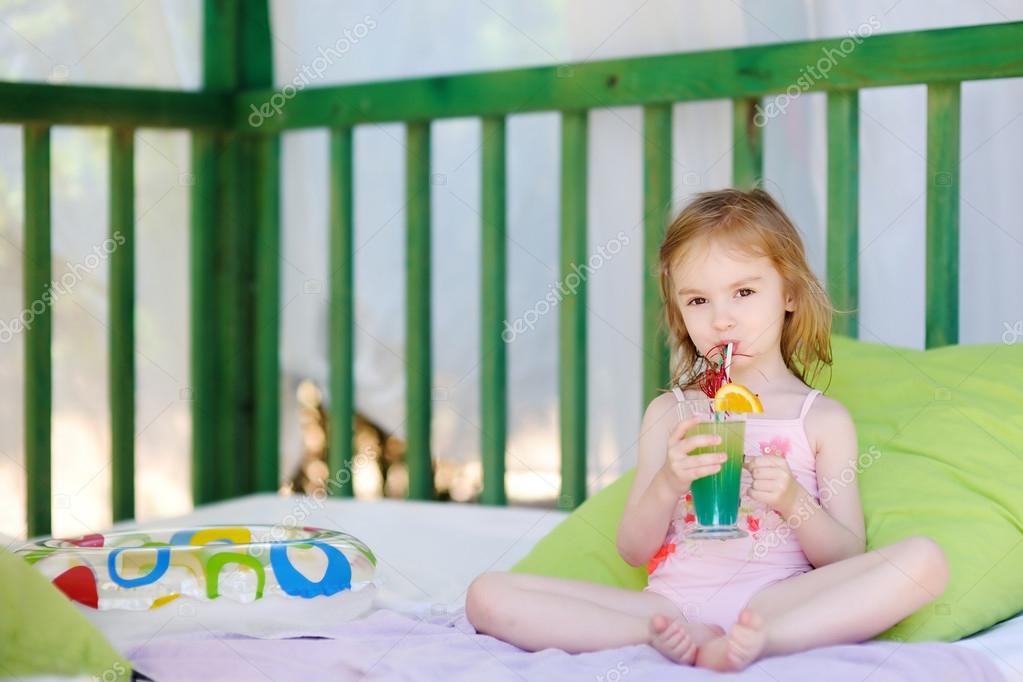 Cute little girl drinking cocktail Stock Photo by ©MNStudio 13725766