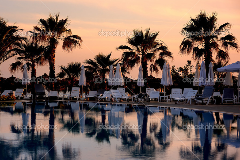 Beautiful swimming pool at sunset — Stock Photo © MNStudio #13726892