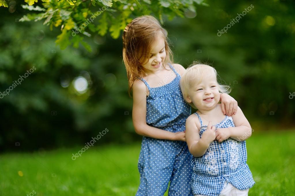 Two sisters portrait outdoors — Stock Photo © MNStudio #43460603