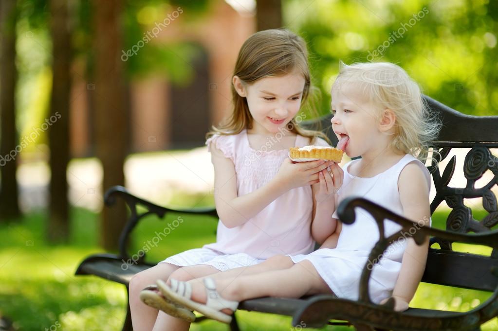 Sisters with cream tart — Stock Photo © MNStudio #50268915