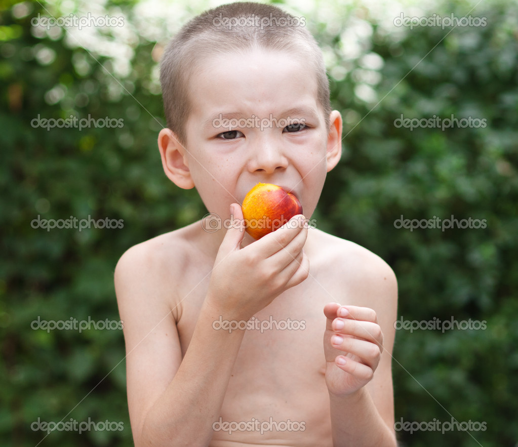 Boy eating a plum Stock Photo by ©papa42 30283363