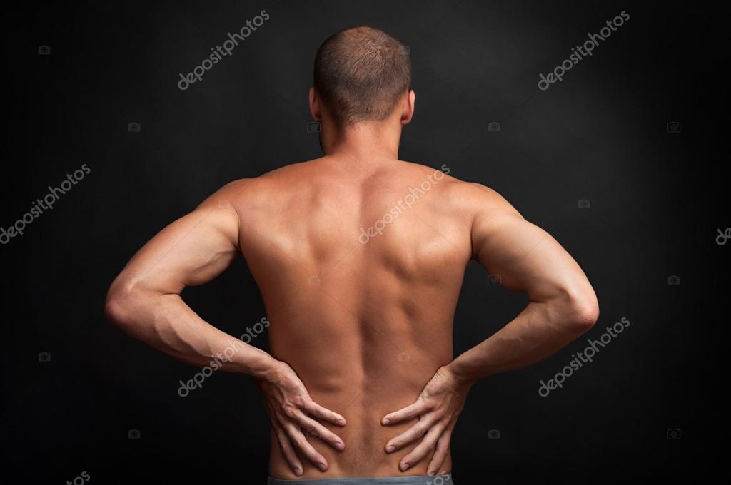 Strong man holding his back with hands Stock Photo by ©vkraskouski 34299485