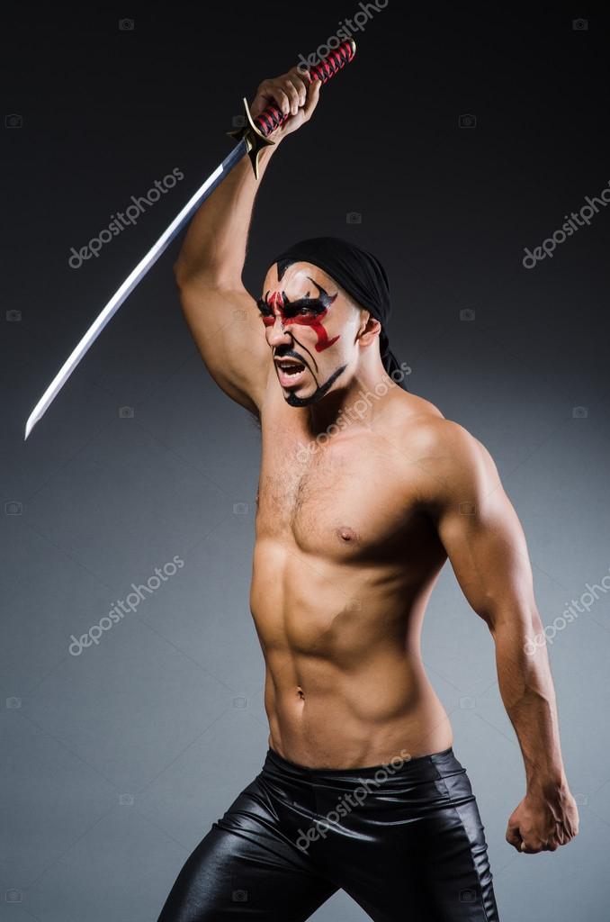 Man with sword and face paint Stock Photo by ©Elnur_ 31432391