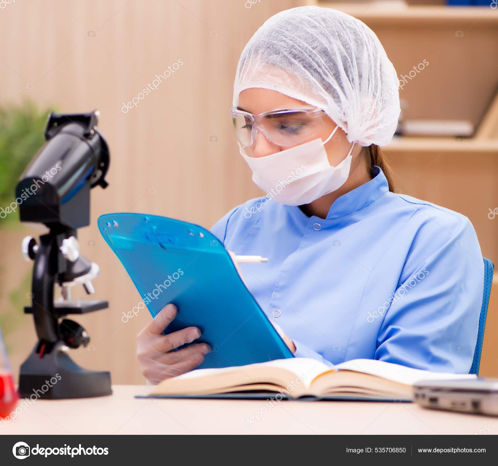 Lab chemist working with microscope and tubes — Stock Photo © Elnur ...