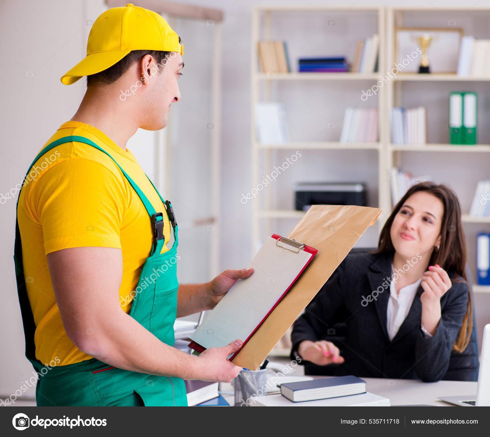 Postman delivering parcel to the office Stock Photo by ©Elnur_ 535711718