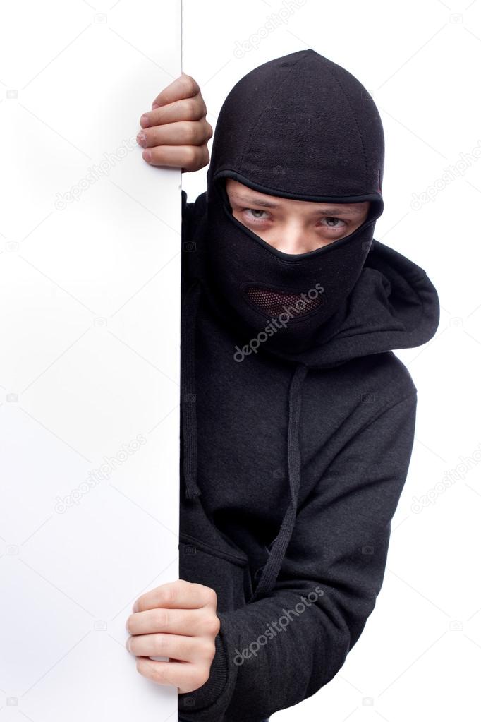 Robber hiding behind a empty white space for text — Stock Photo ...