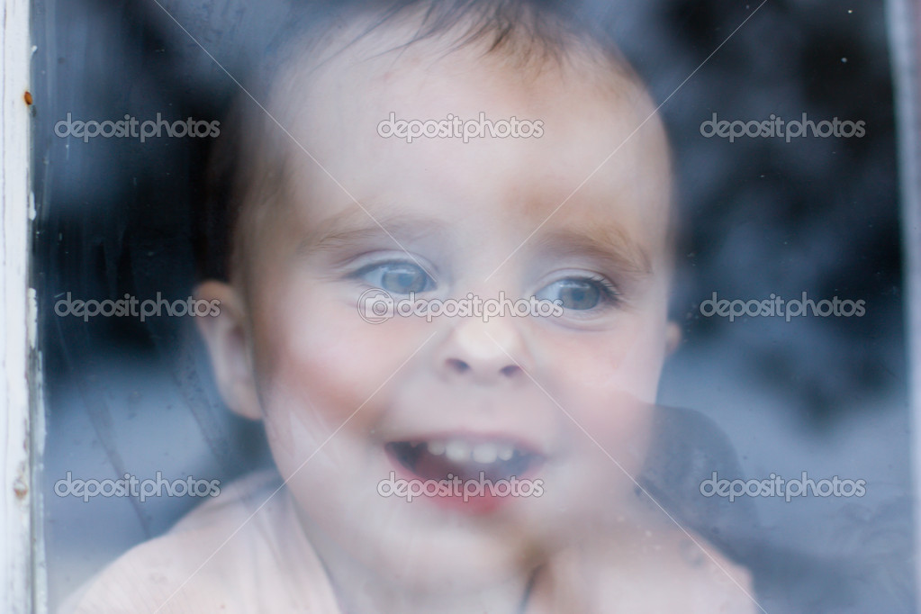 Young baby looking from window Stock Photo by ©khamidulin 12830706