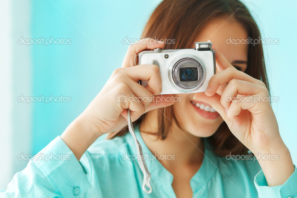 Portrait of a beautiful cute teen girl with digital photo camera ...