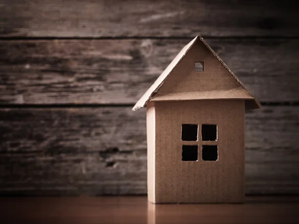 house in brown recycled paper on wooden background - Stock Image ...