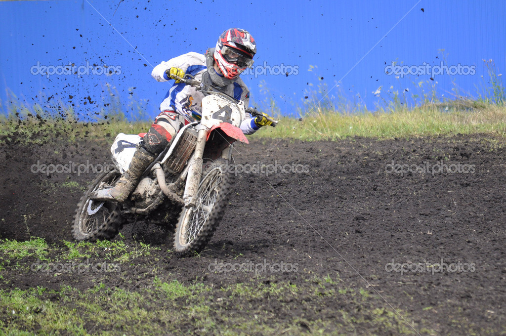 Racers on motorcycles participate in cross-country race competit ...