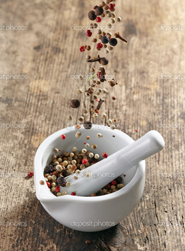 Various spices falling into mortar and pestle — Stock Photo © zmaris ...