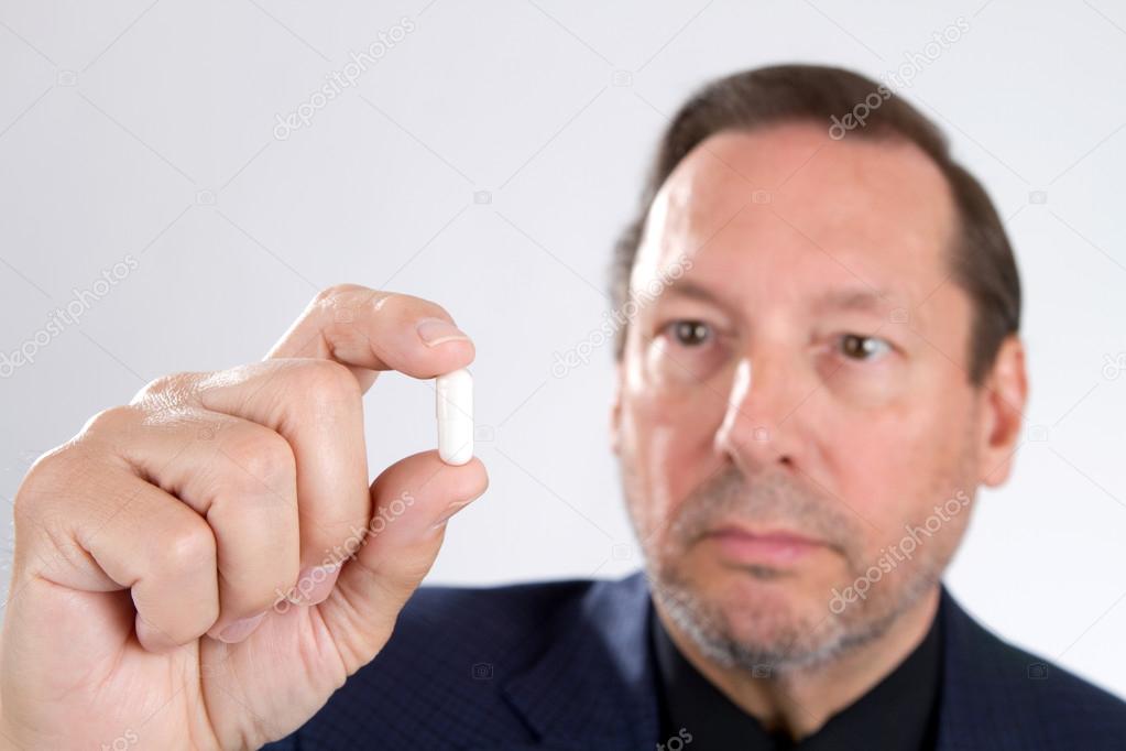 Man Holding Pill Capsule Stock Photo by ©sframe 24870585