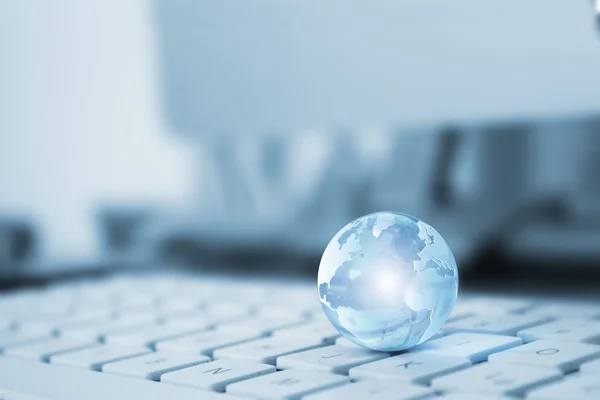 Transparent globe on a keyboard - Stock Image - Everypixel