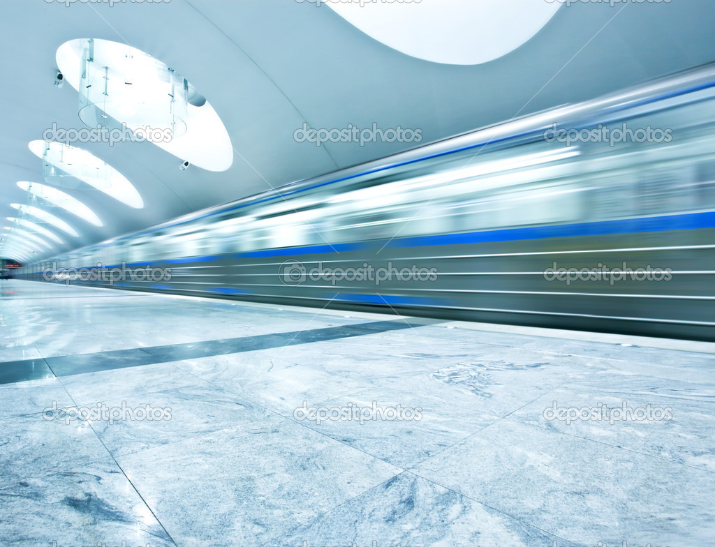 Perspective wide angle view of modern light blue illuminated and ...