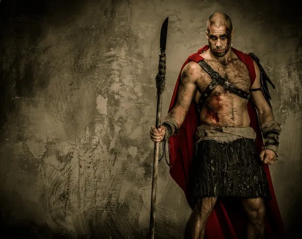Wounded gladiator with two swords covered in blood Stock Photo by ...