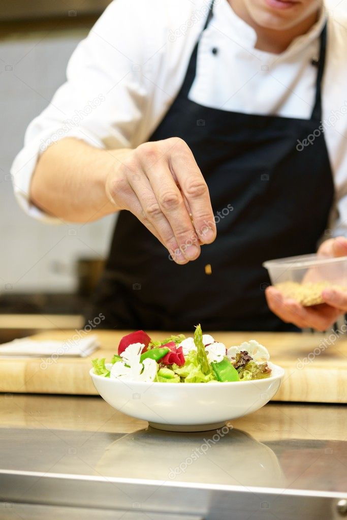 Chief cook preparing salad — Stock Photo © nejron #40276899