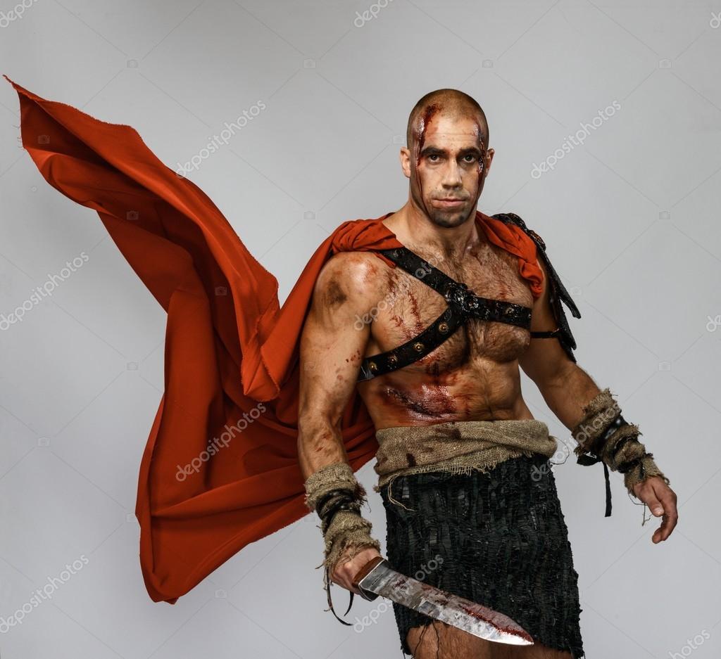 Wounded gladiator with sword covered in blood isolated on grey Stock ...