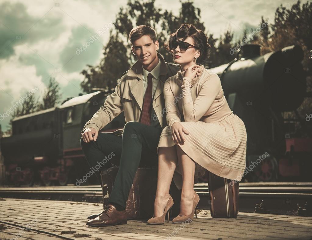 Vintage style couple on train station — Stock Photo © nejron #45399917