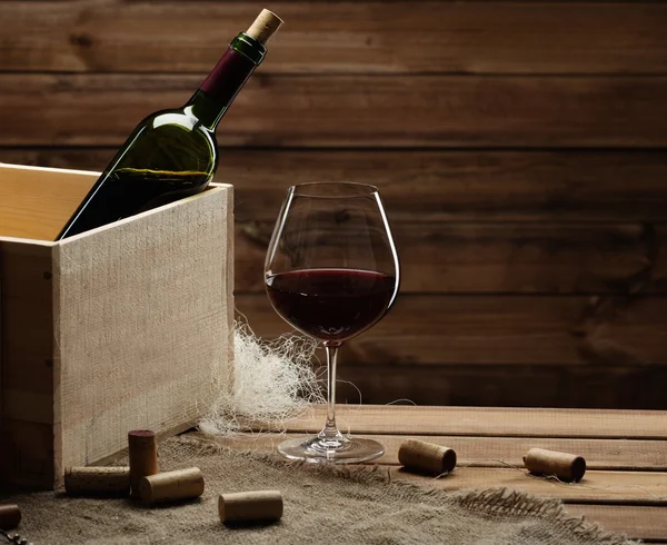 Bottle and glass of red wine on a wooden table Stock Photo by ©nejron ...