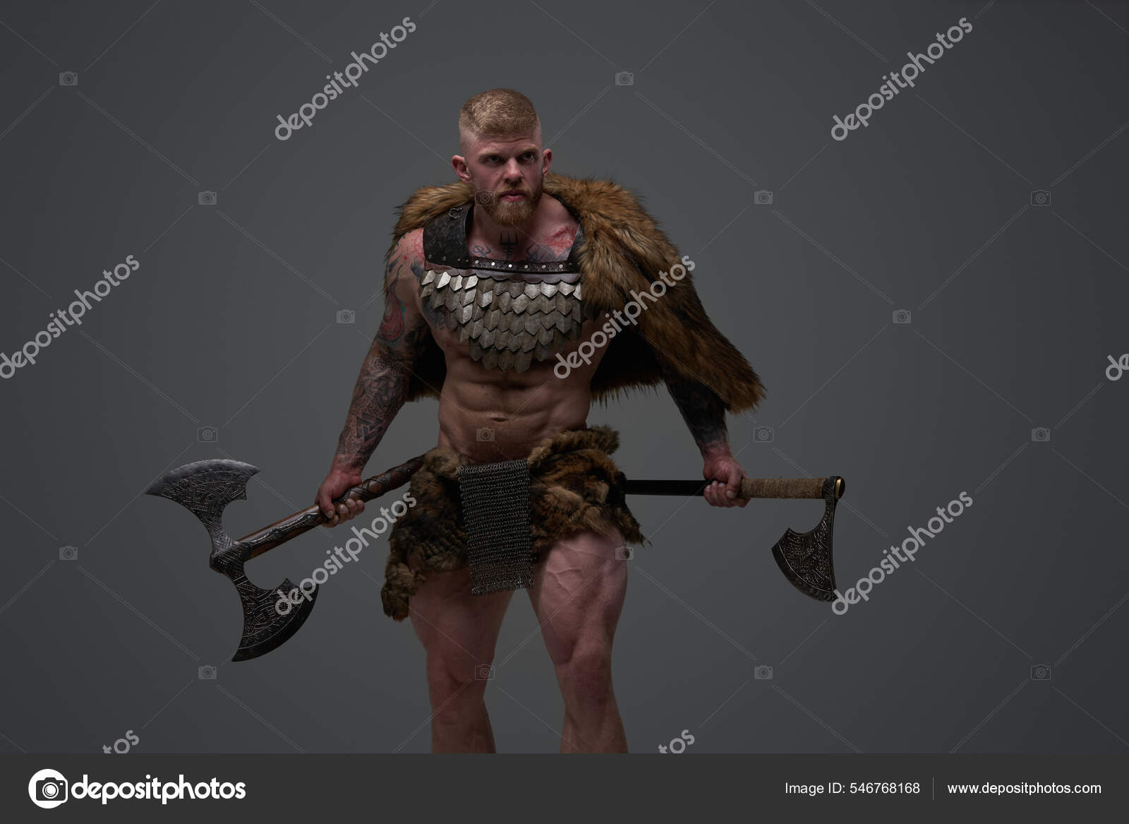 Furious viking dressed in fur and armor holding two axes — Stock Photo ...