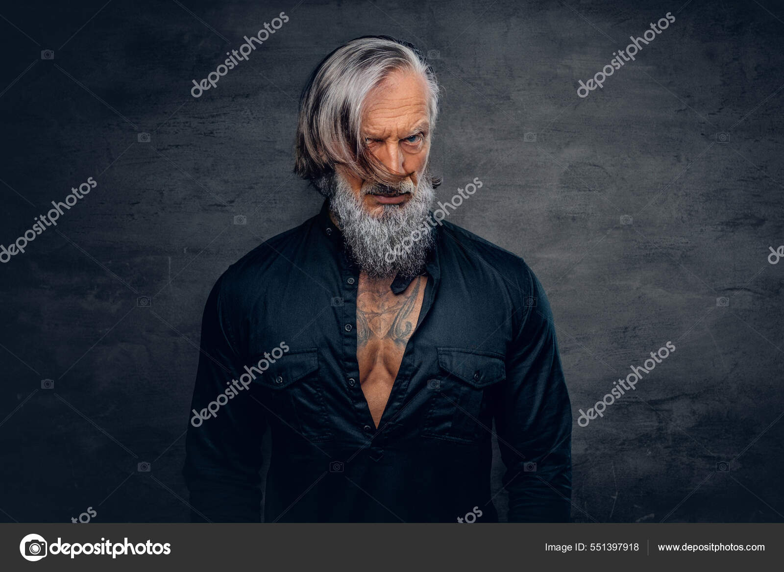 Handsome elderly man dressed in black shirt against dark background ...