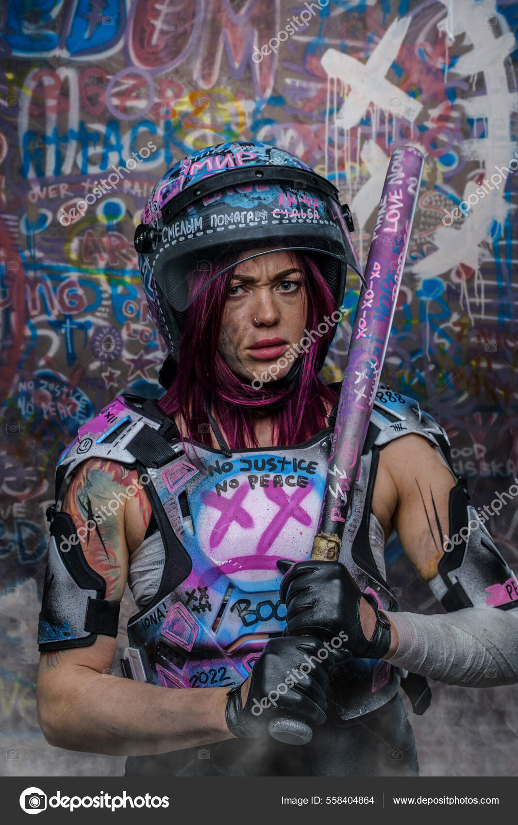Violent woman protester dressed in painted vest holding baseball bat ...