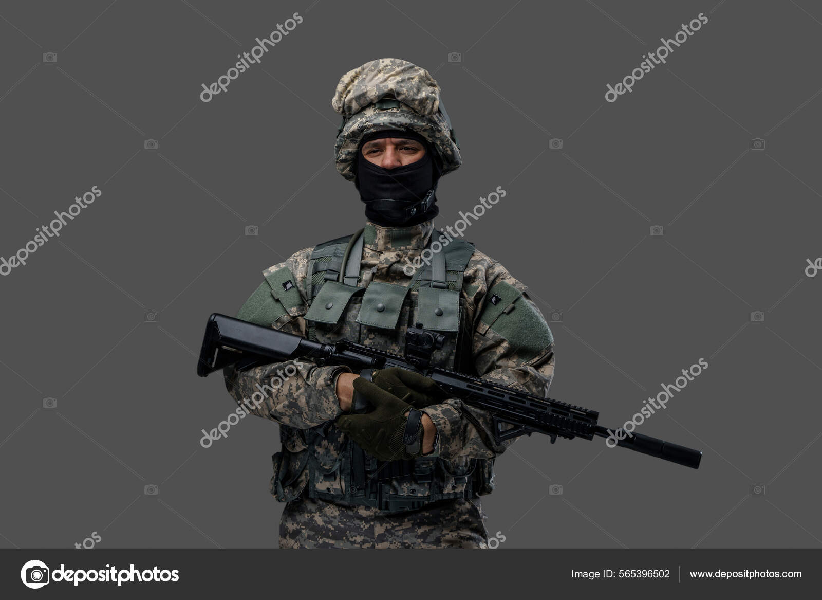 Military man with rifle dressed in camouflage uniform and helmet ...
