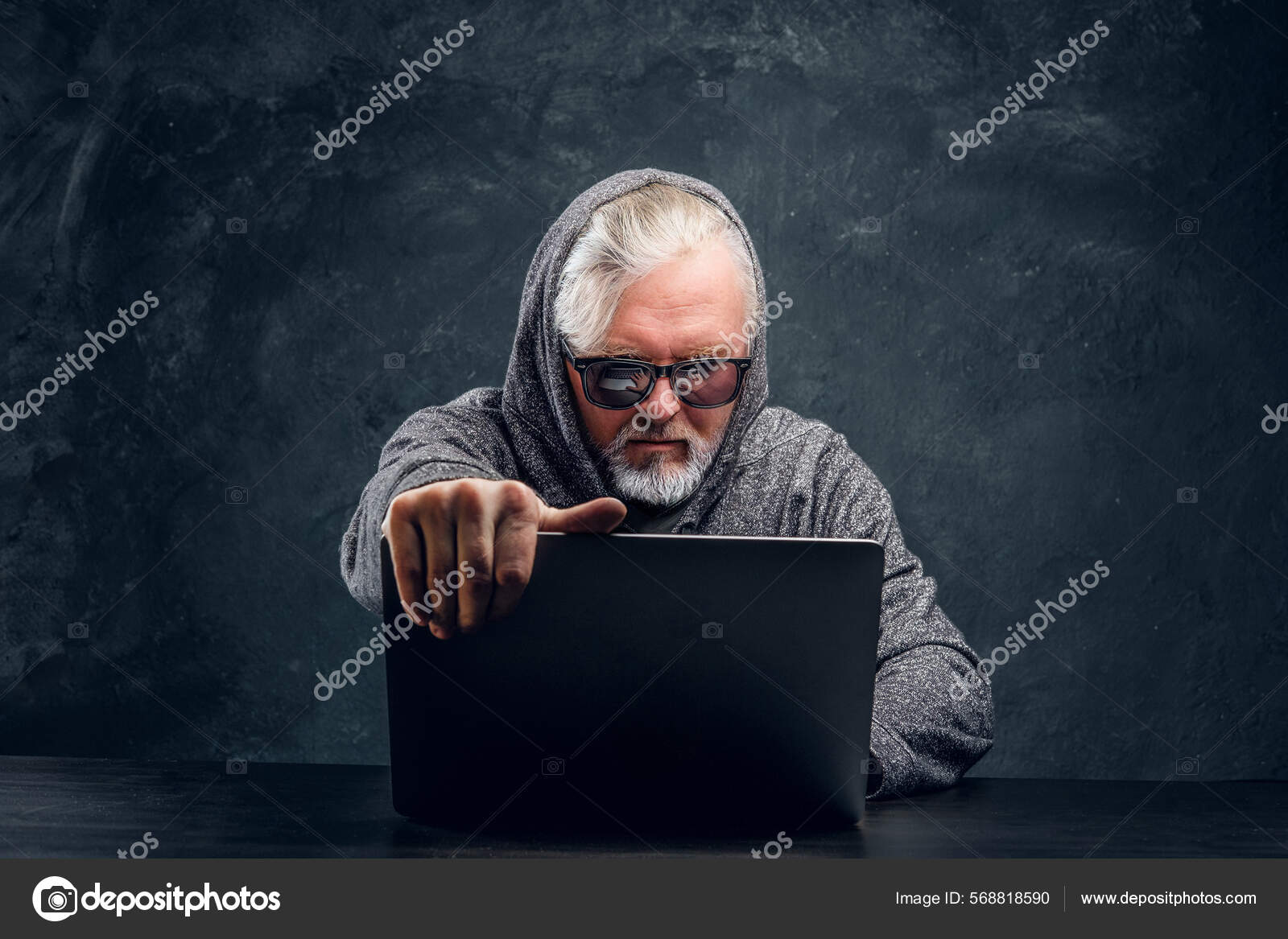 Old man hacker with laptop against dark background Stock Photo by ...