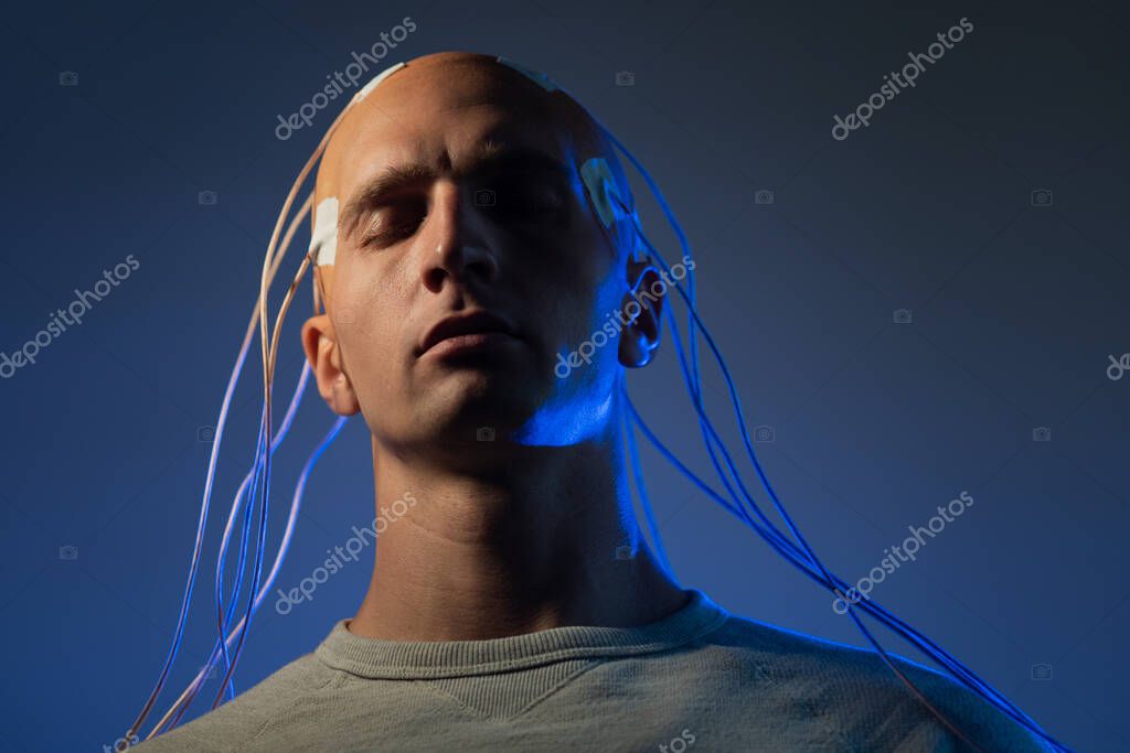 Un joven con la cabeza enredada con cables, un retrato 2024