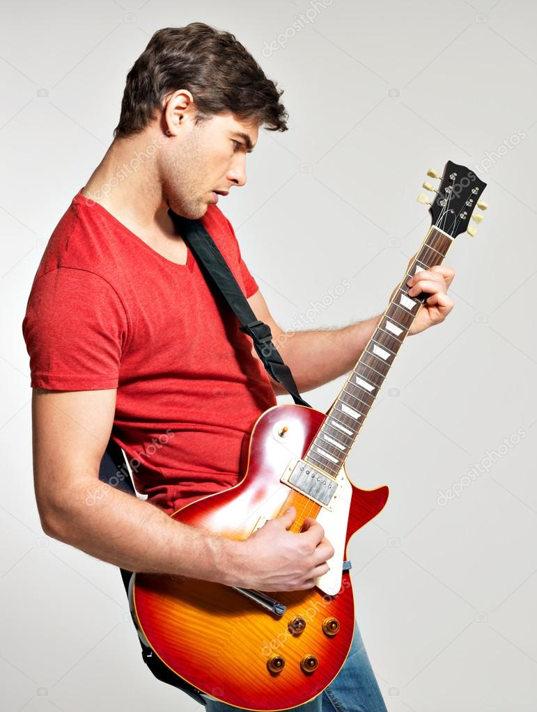 Guitarist plays on the electric guitar — Stock Photo © valuavitaly ...