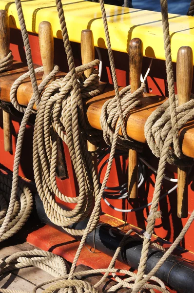 Coiled rope lines stored on belaying pins - Stock Image - Everypixel