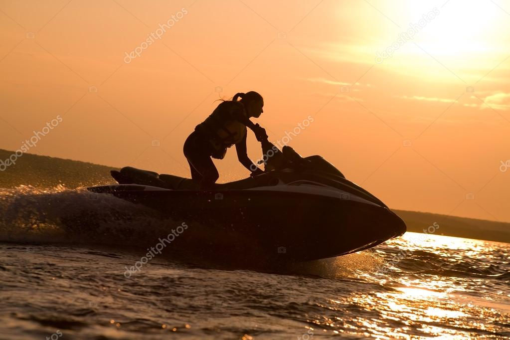 Beautiful girl riding her jet skis — Stock Photo © yanlev #19261205