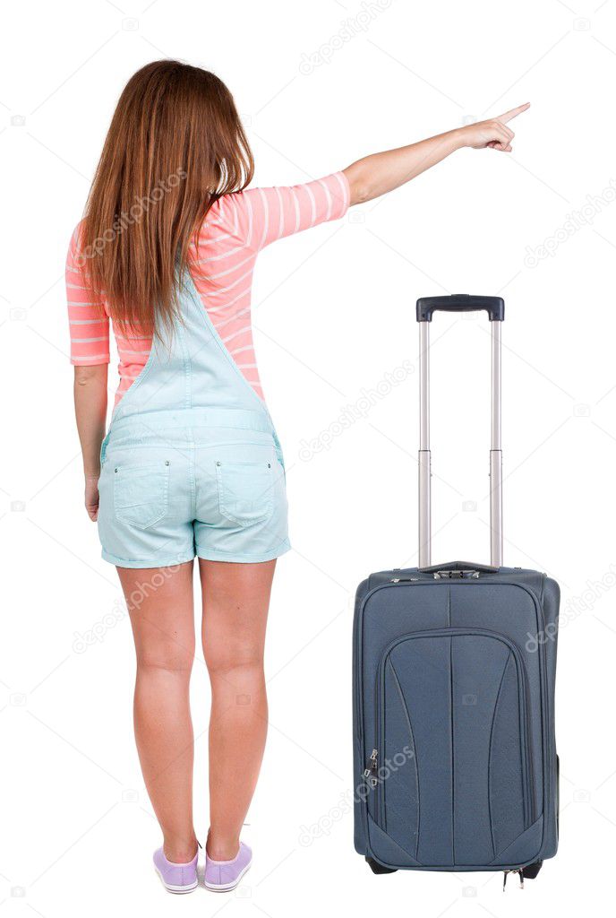 Back view of traveling pointing woman with suitcase Stock Photo by ...