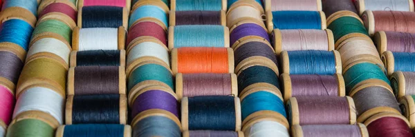 Multi-colored spools of thread close-up. Sewing threads multicolored ...